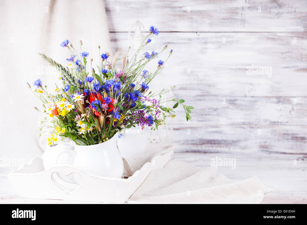 Wildflowers in white ceramic jug and cups on tray with copy space Stock ...
