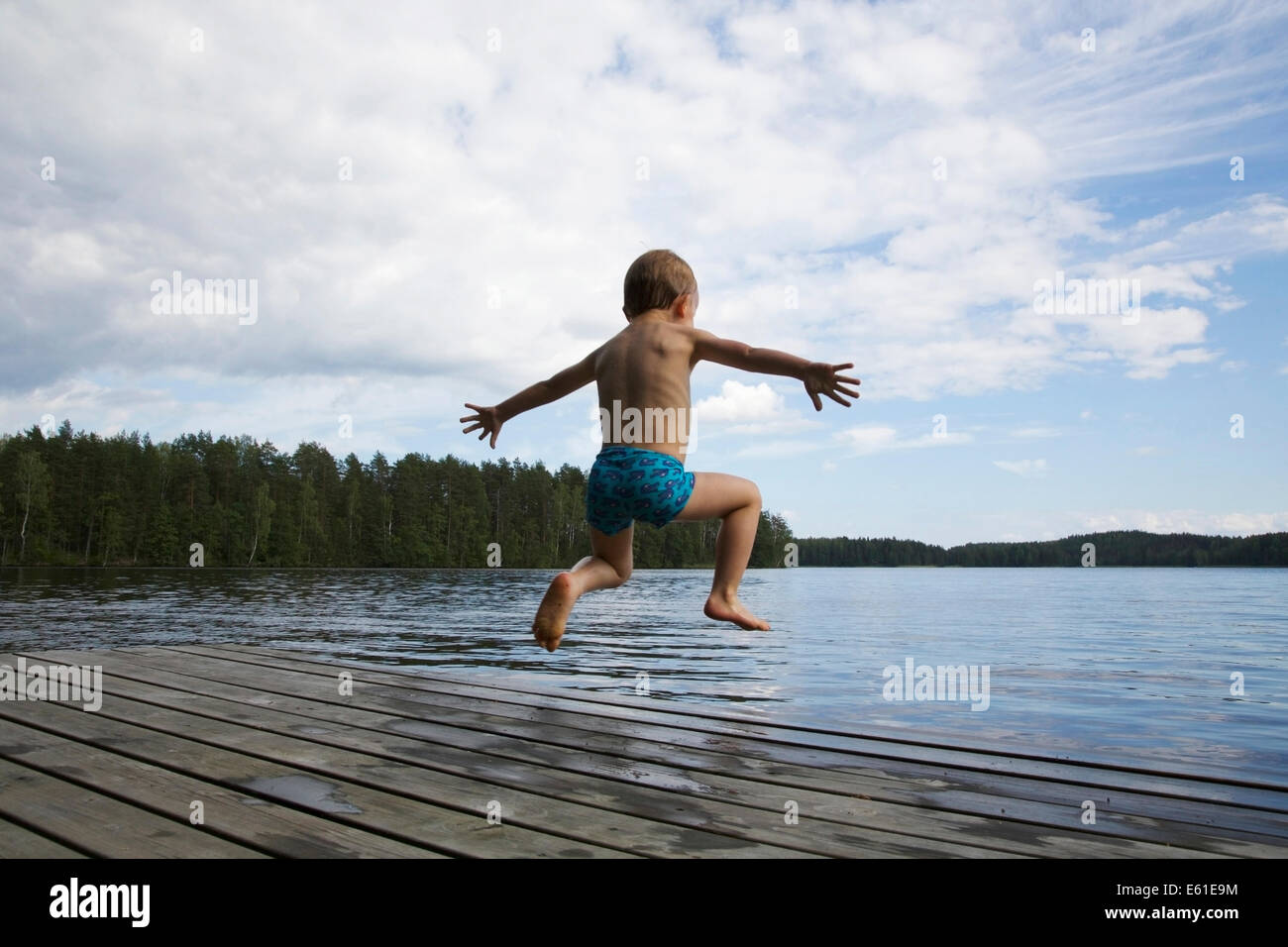 Boy jumping off pier hi-res stock photography and images - Alamy