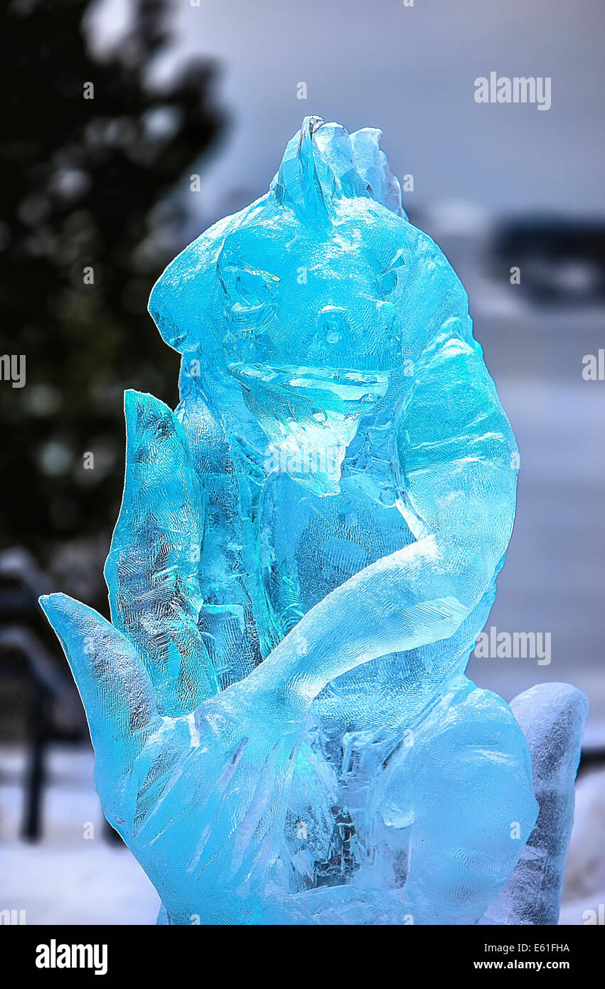 Ice sculpture of a lizard sitting on a human hand Stock Photo - Alamy