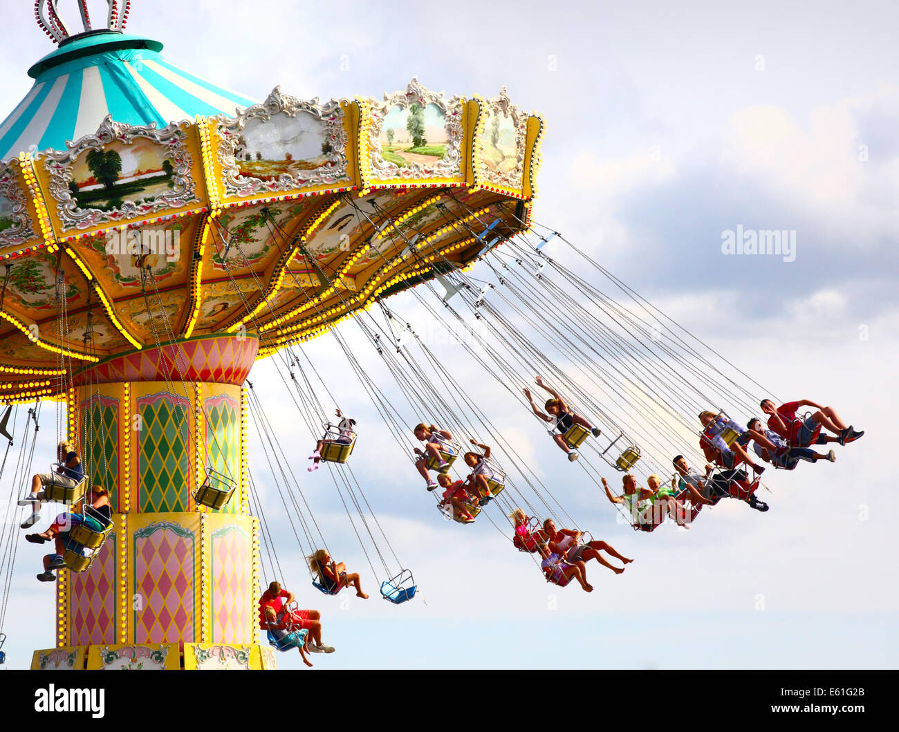 People having fun on a chair carousel Stock Photo - Alamy