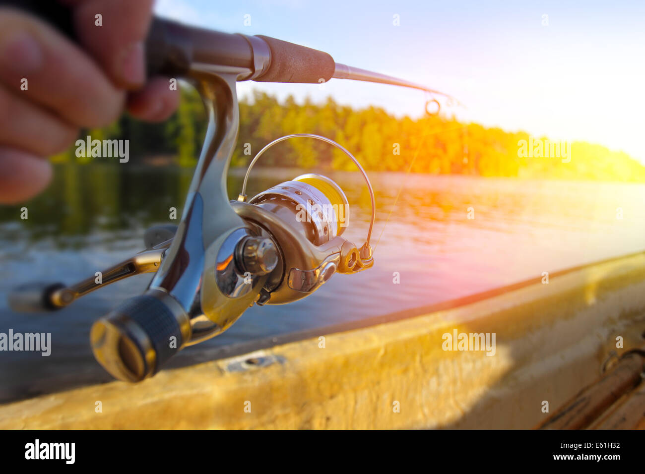 Fishing at sunset Stock Photo - Alamy