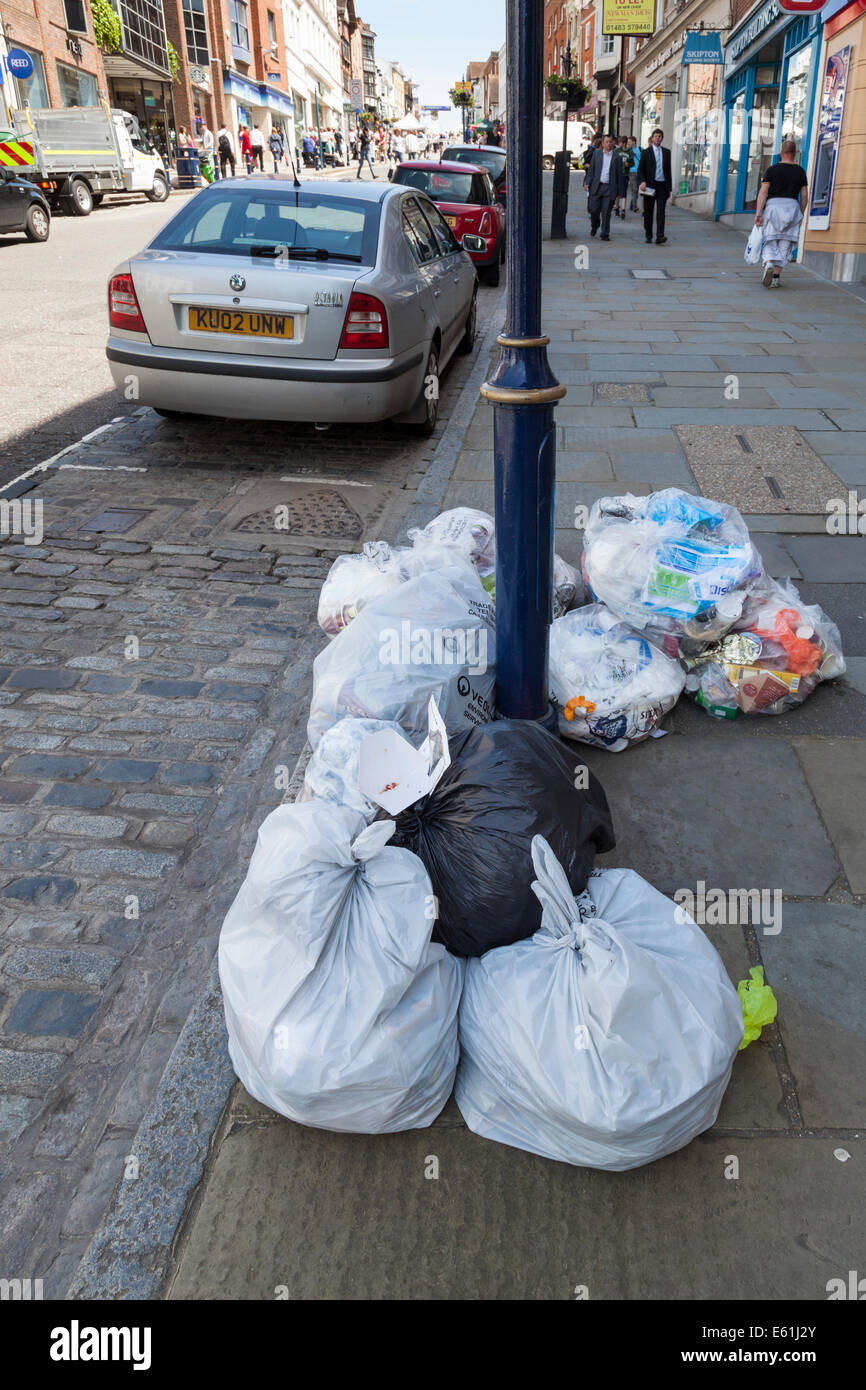 Rubbish in bags on the pavement awaiting collection Stock Photo - Alamy