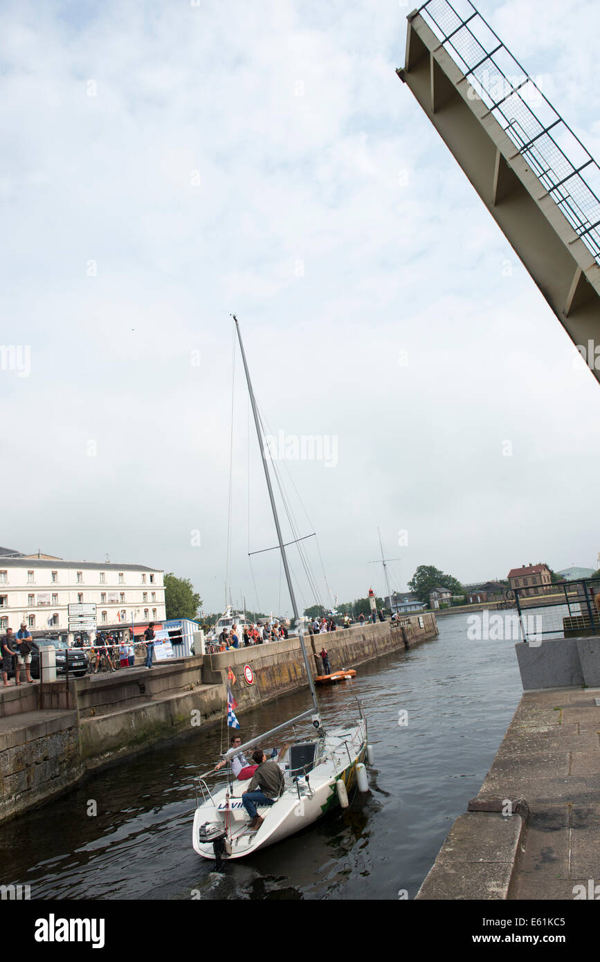 Boat passing through the bridge from the harbour in Honfleur, Normandy ...