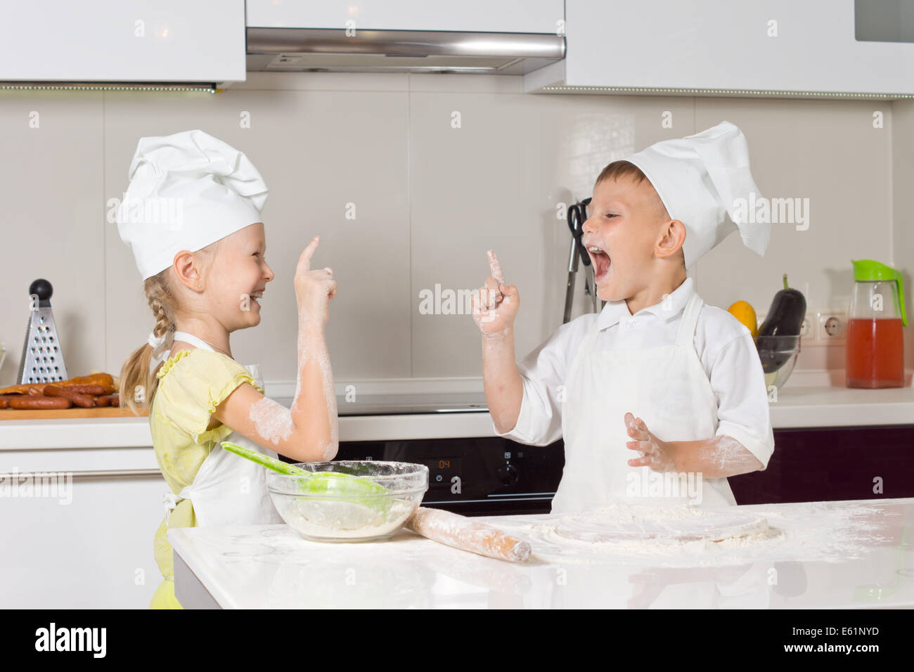 Very Happy Little Kids in Chefs Attire Playing in the Kitchen Stock ...