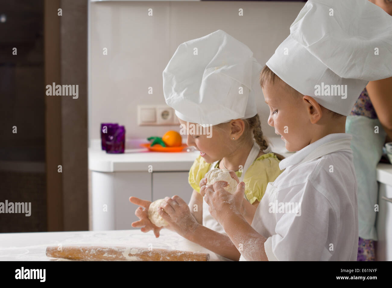 Cute Kid Chefs Baking for Pizza at the Kitchen Stock Photo - Alamy