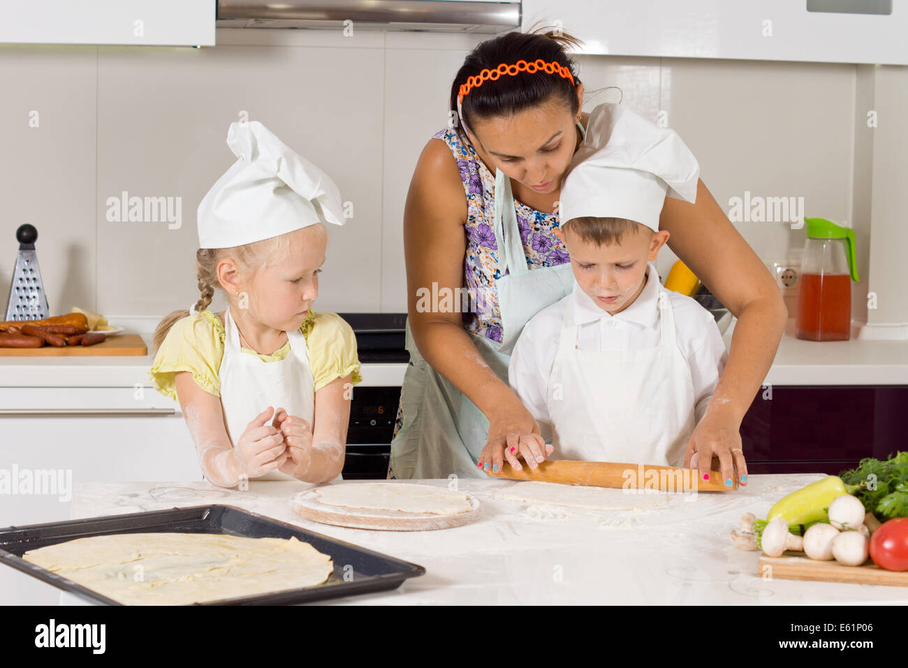 Mother Teaches How to Make Pizza to Kids Wearing Chefs Attire at the ...