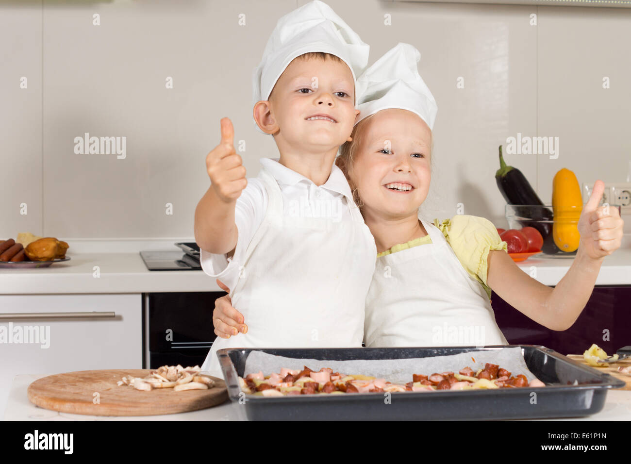 Two Little Chefs Showing Thumbs Up Emphasizing Good Job in Baking Pizza ...