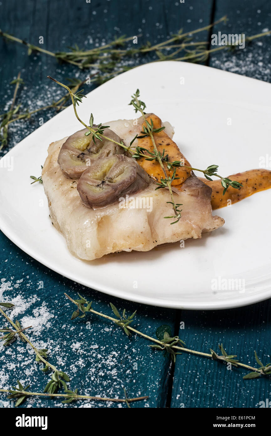 piece of fragrant roasted fish in sauce and spices Stock Photo - Alamy