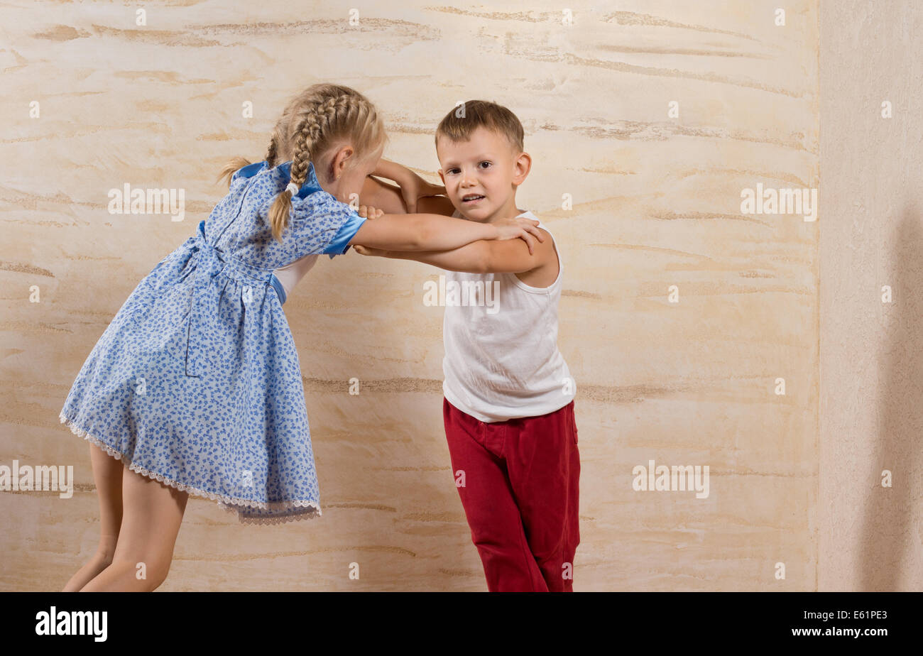Cute Little White Kids Playing at Home Isolated on Light Brown Wooden ...