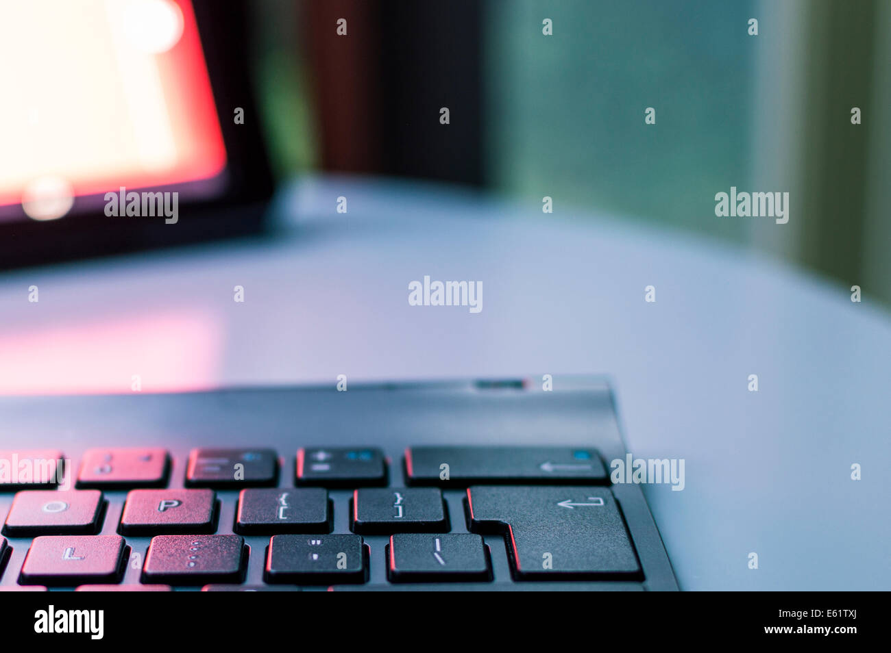 close-up shot of a Bluetooth keyboard positioned in front of a tablet ...