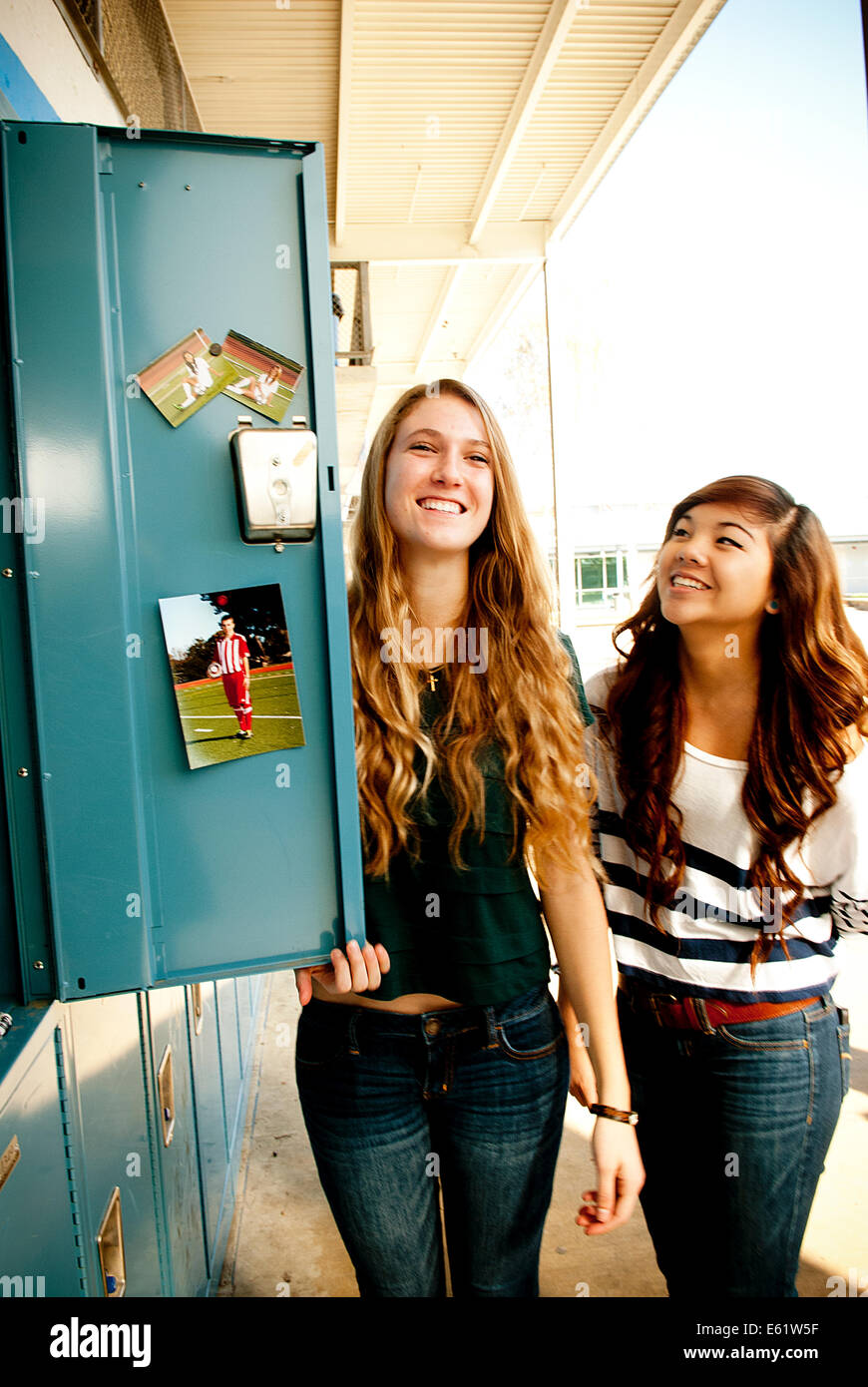 Friends near open locker Stock Photo - Alamy