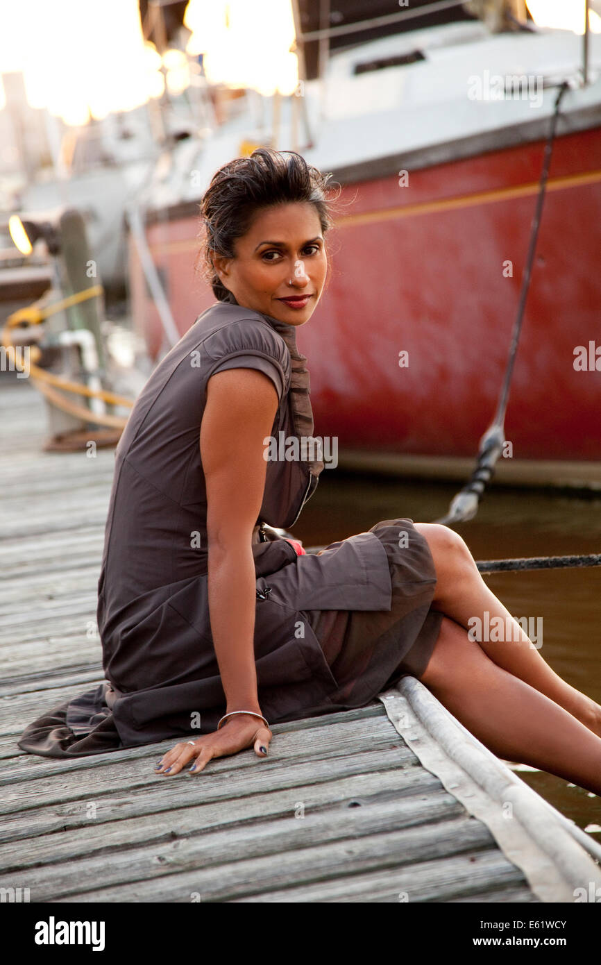Portrait of woman standing on jetty Stock Photo - Alamy