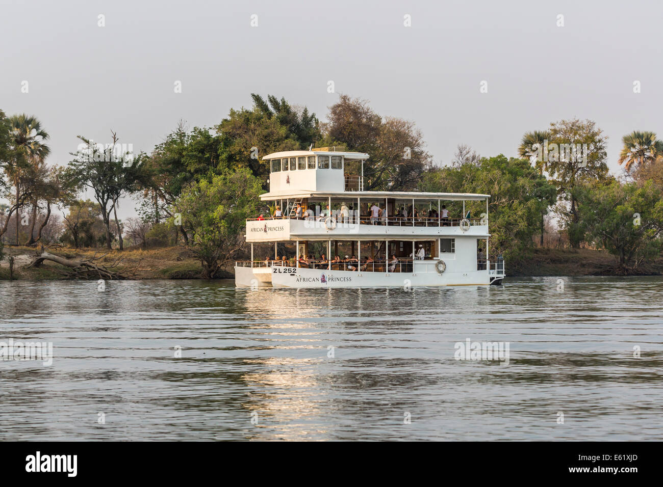 Tourists enjoy an evening riverboat cruise on the 'African Princess' on ...