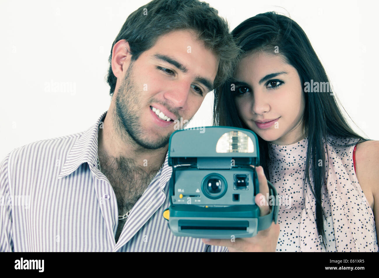 Cute couple taking photos with instant old camera Stock Photo - Alamy