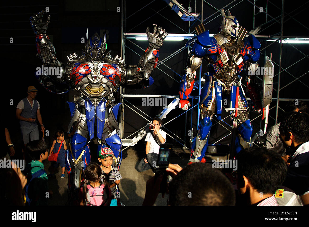Visitors take pictures of the latest version of Optimus Prime on the ...