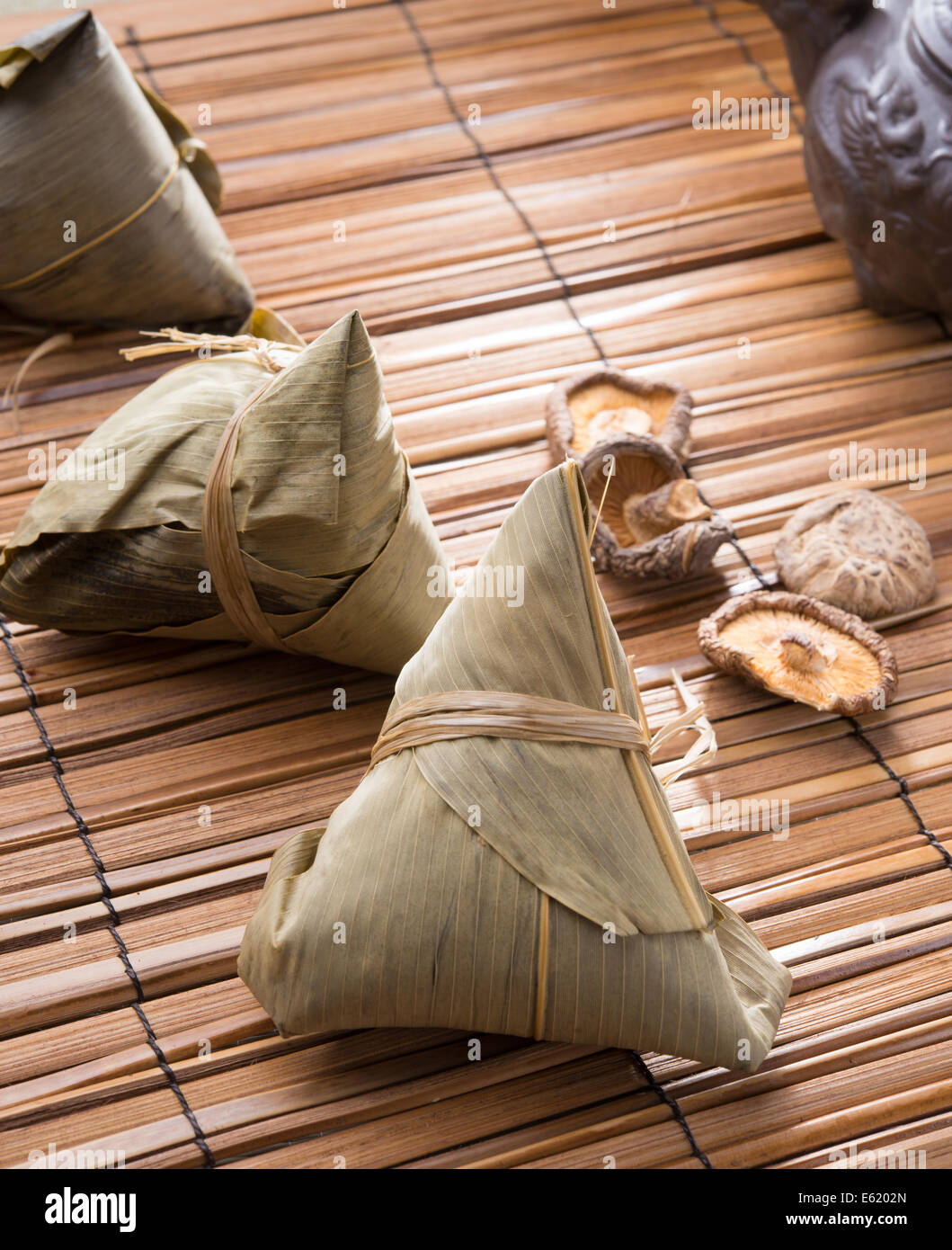 Three rice dumplings and chinese tea on bamboo place mat Stock Photo ...