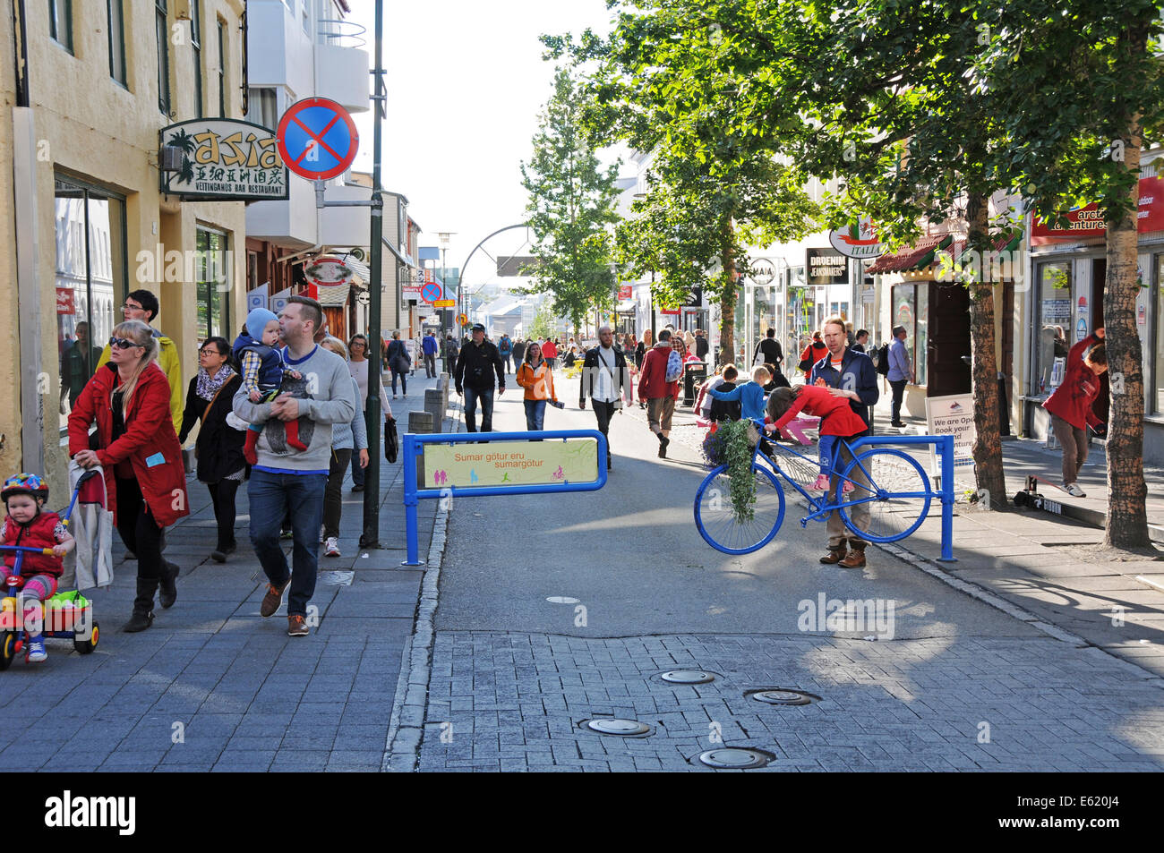 People, shops, side walk restaurants and pubs on Laugavegur Street in ...