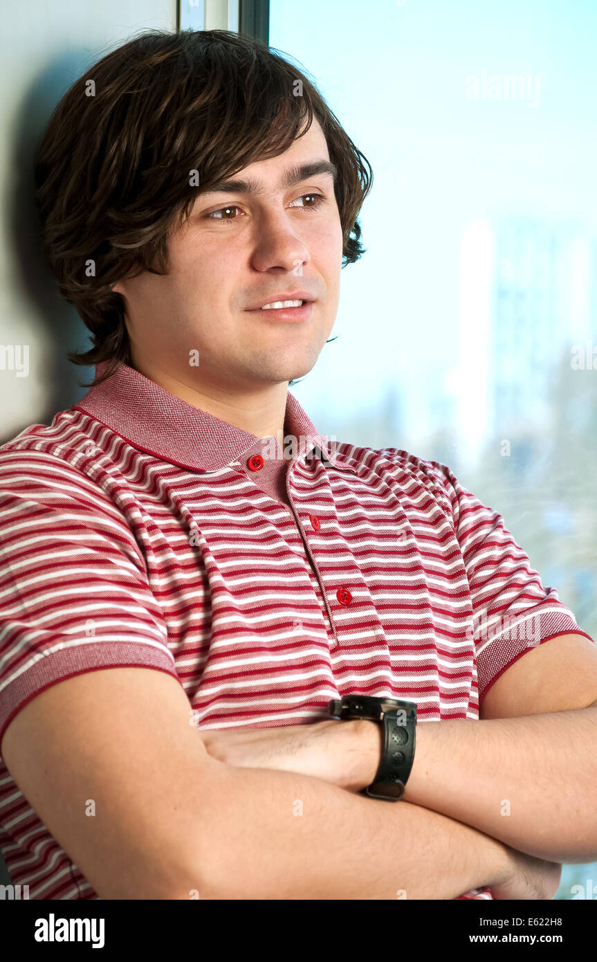 Portrait of handsome young man looking at the window Stock Photo - Alamy