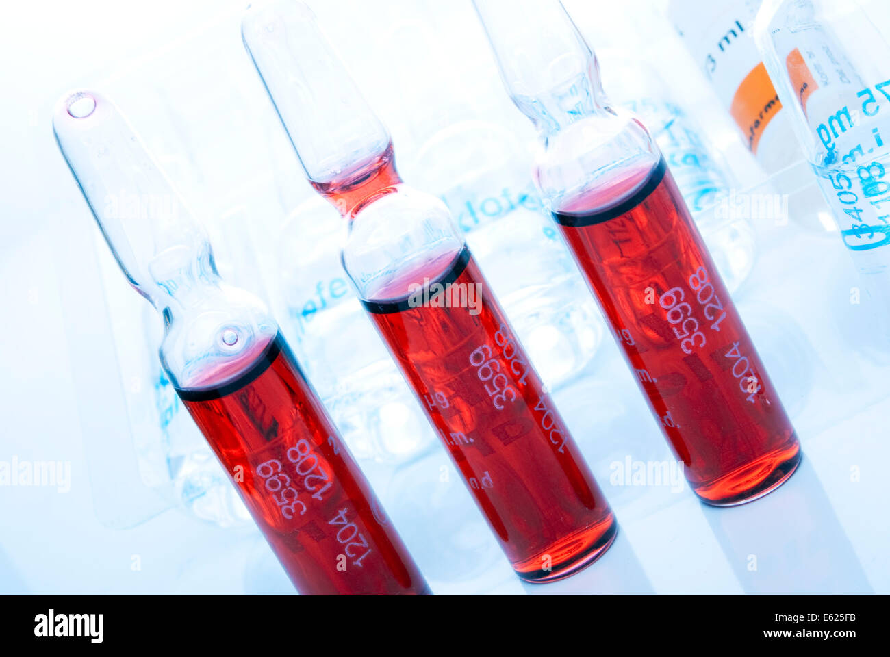 Closeup of medical ampules with red liquid inside Stock Photo - Alamy