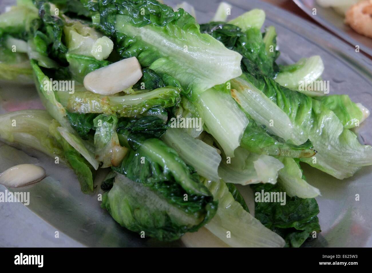 Stir Fried Lettuce with Garlic Stock Photo - Alamy