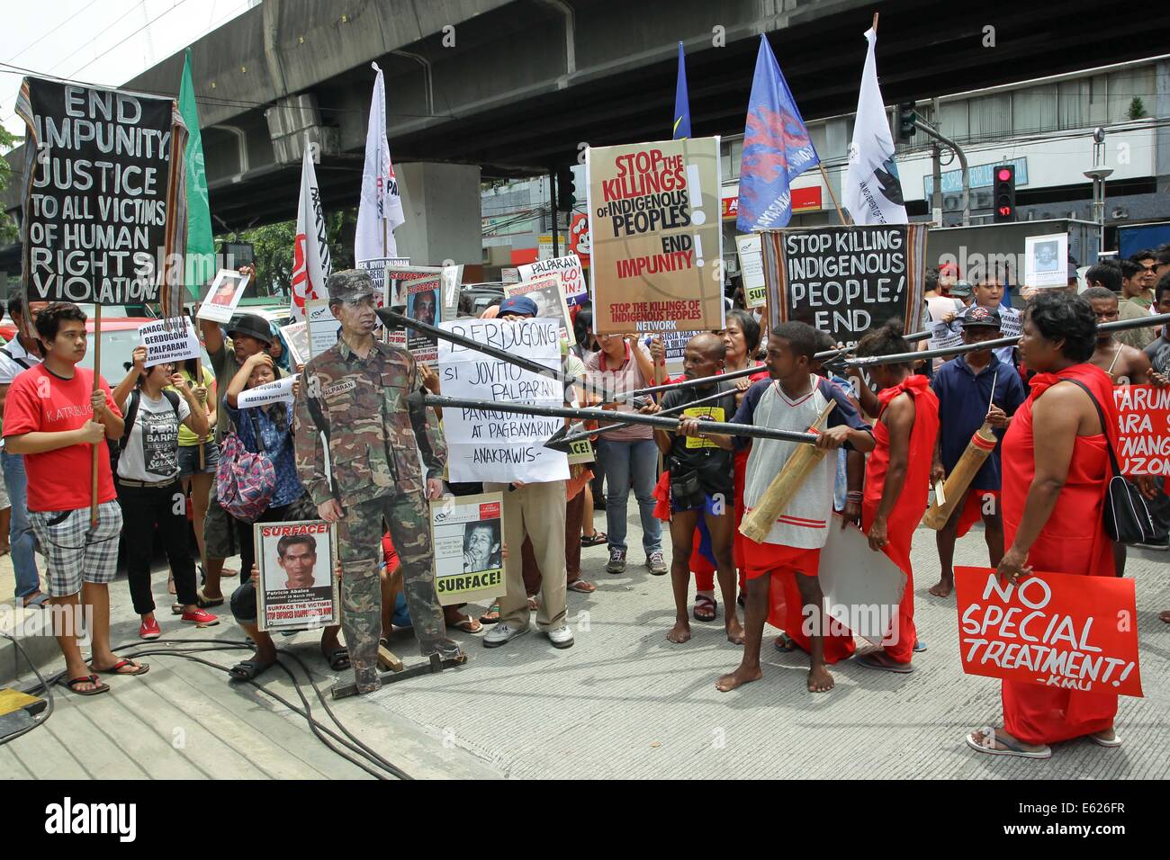 Indigenous people poke a poster of Maj. Gen. Jovito Palparan outside ...