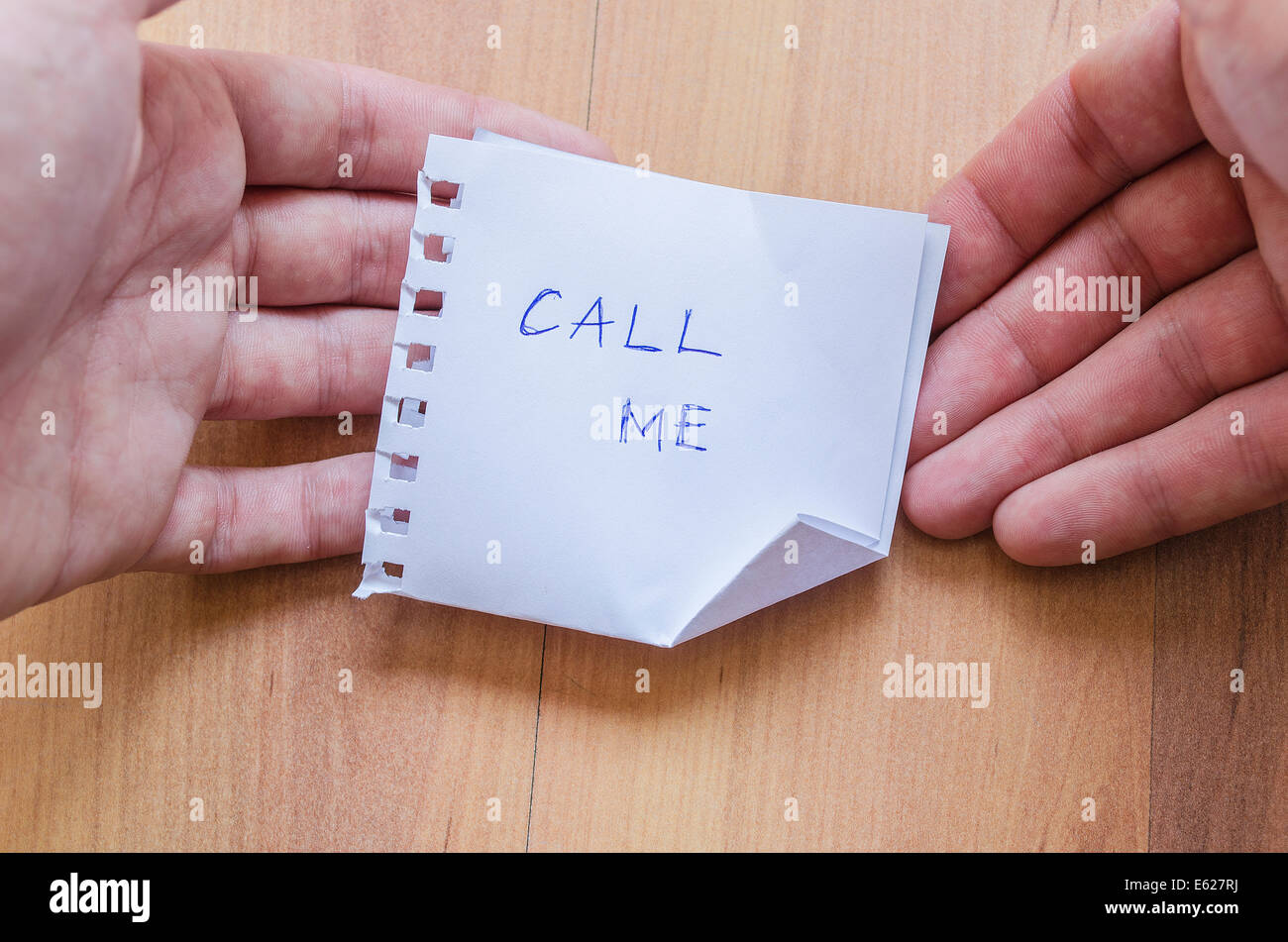 Call Me Note in a human hands Stock Photo - Alamy