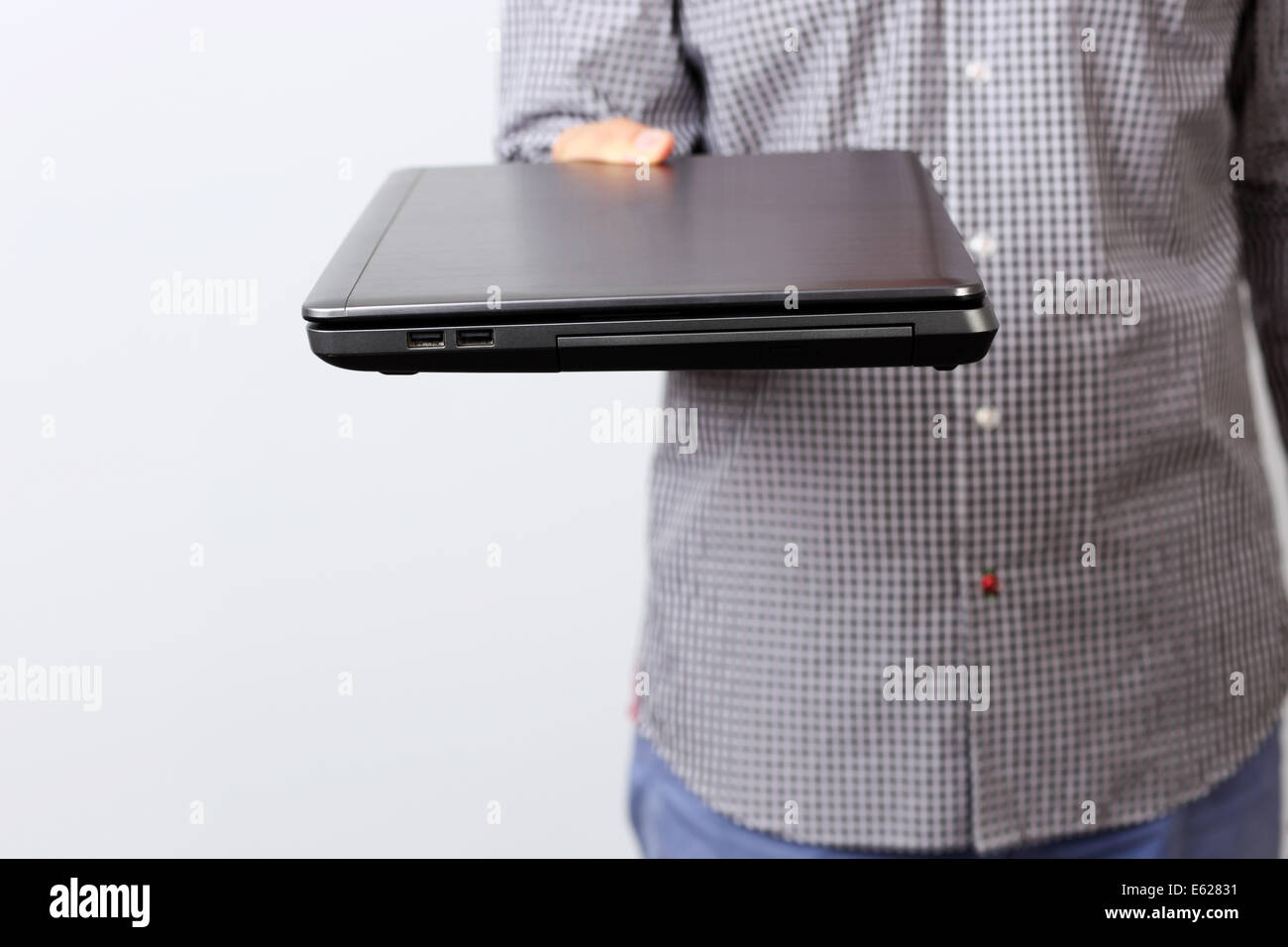 Closeup portrait of a male hand holding laptop Stock Photo - Alamy