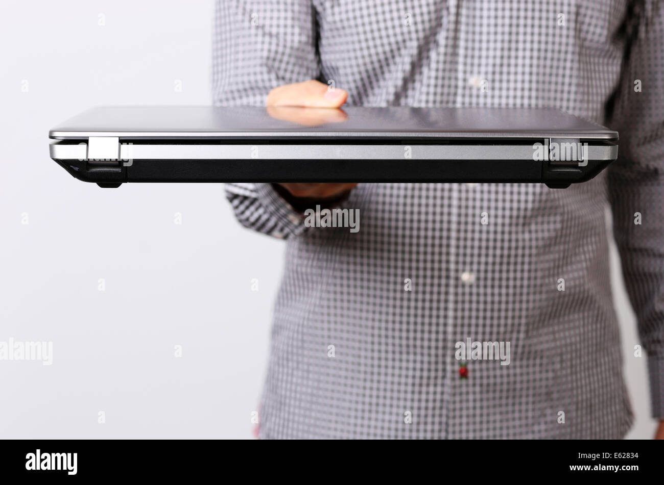 Closeup portrait of a male hand holding laptop Stock Photo - Alamy