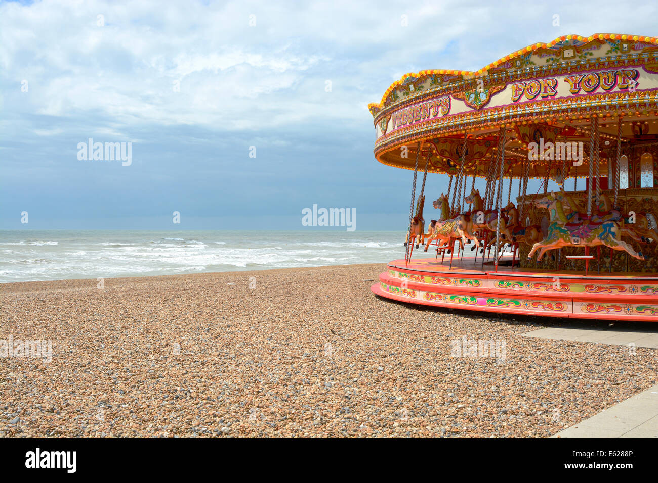 Traditional fairground roundabout on the beach at Brighton in East ...