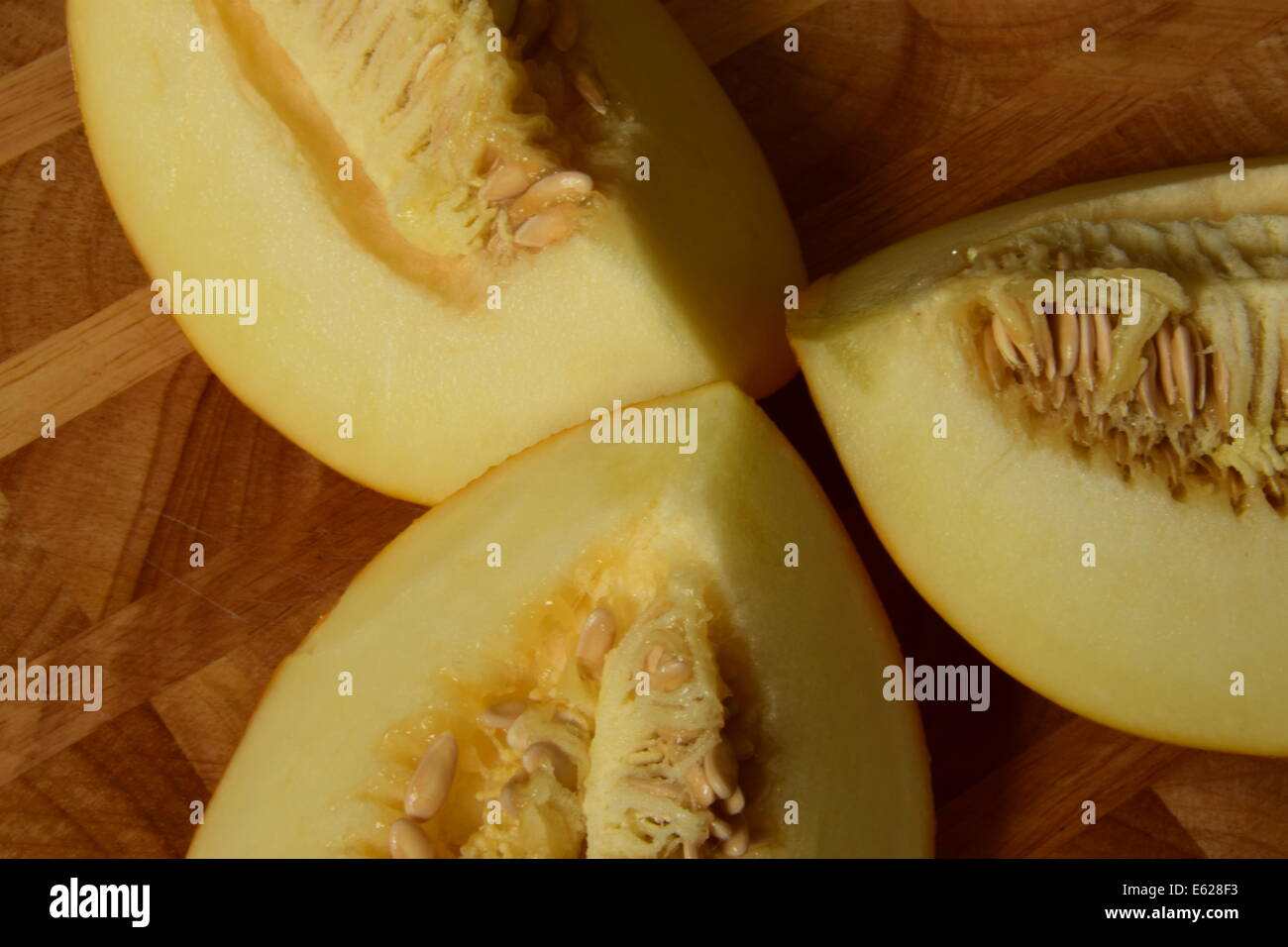 A melon cut in pieces and arranged on a wooden board Stock Photo - Alamy
