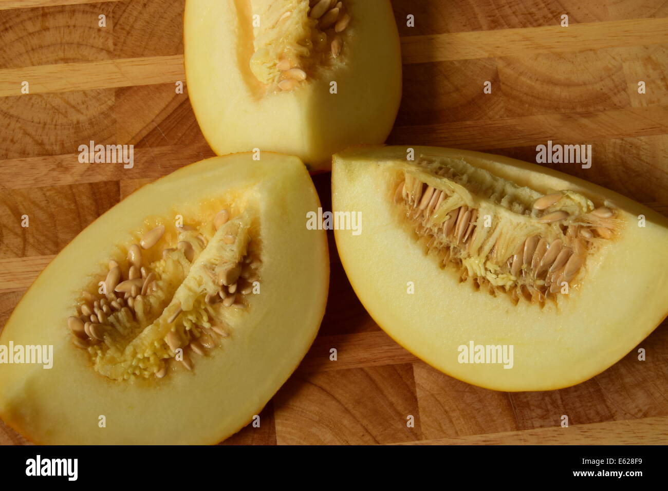 A melon cut in pieces and arranged on a wooden board Stock Photo - Alamy