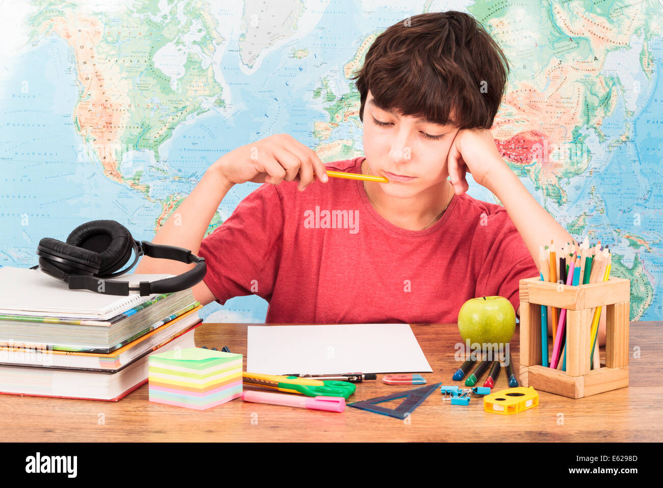 Young boy thinking about his homework Stock Photo - Alamy
