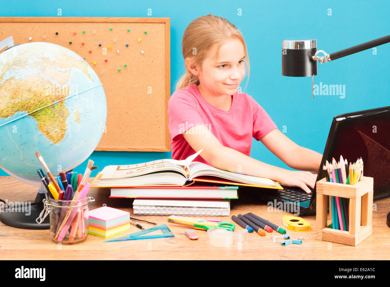 Young smiling girl doing her homework Stock Photo - Alamy