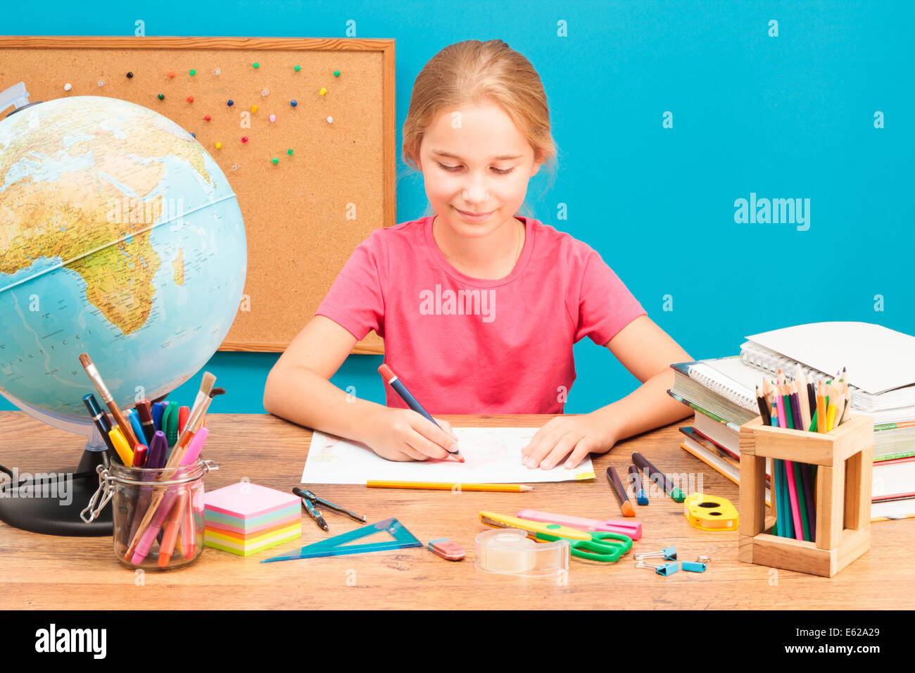 Young smiling girl doing her homework Stock Photo - Alamy