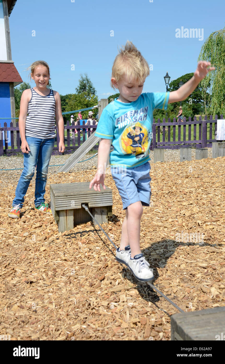 Young boy balancing on wire Stock Photo - Alamy