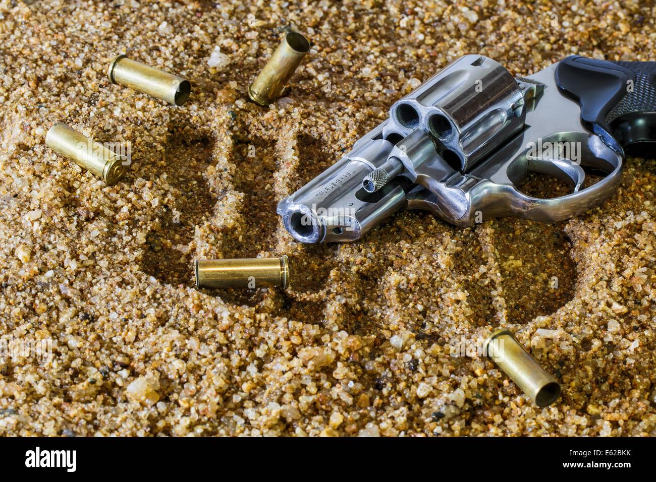 A revolver firearm, loaded with bullets, is depicted as a dangerous ...