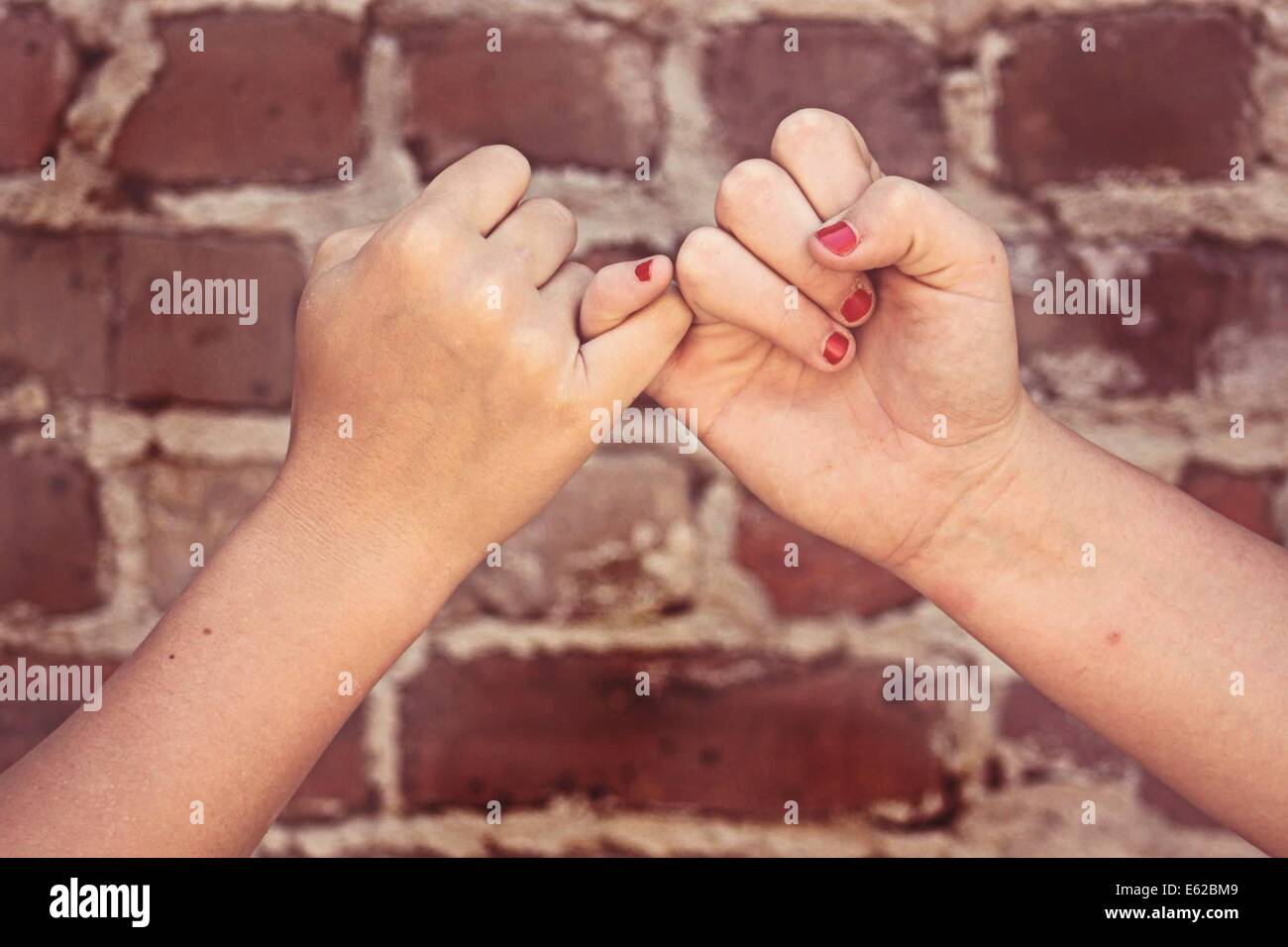 A symbolic image of a pinky swear between two friends, representing a ...