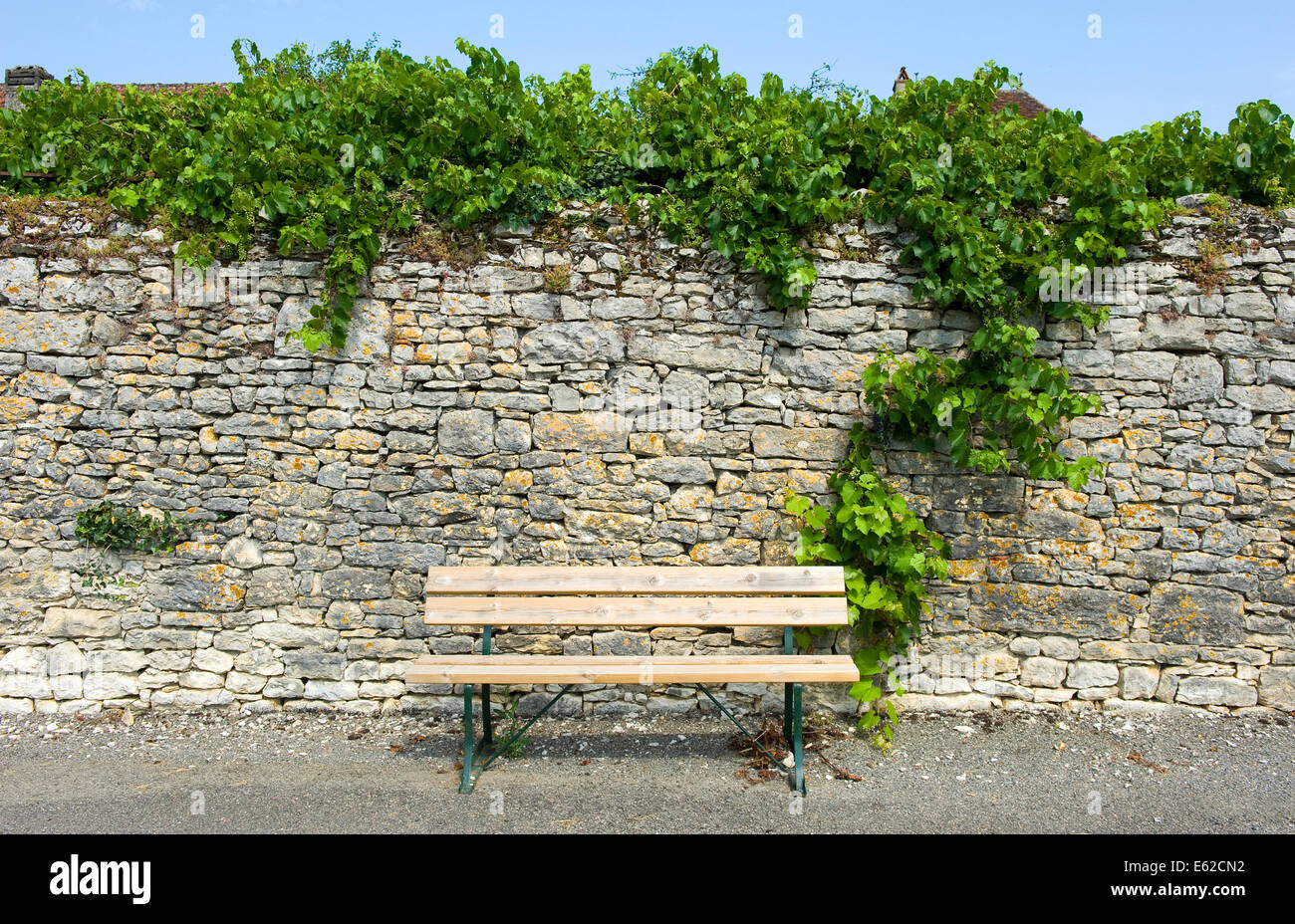 A bench in front of a stone wall in the city of Martel in France Stock ...