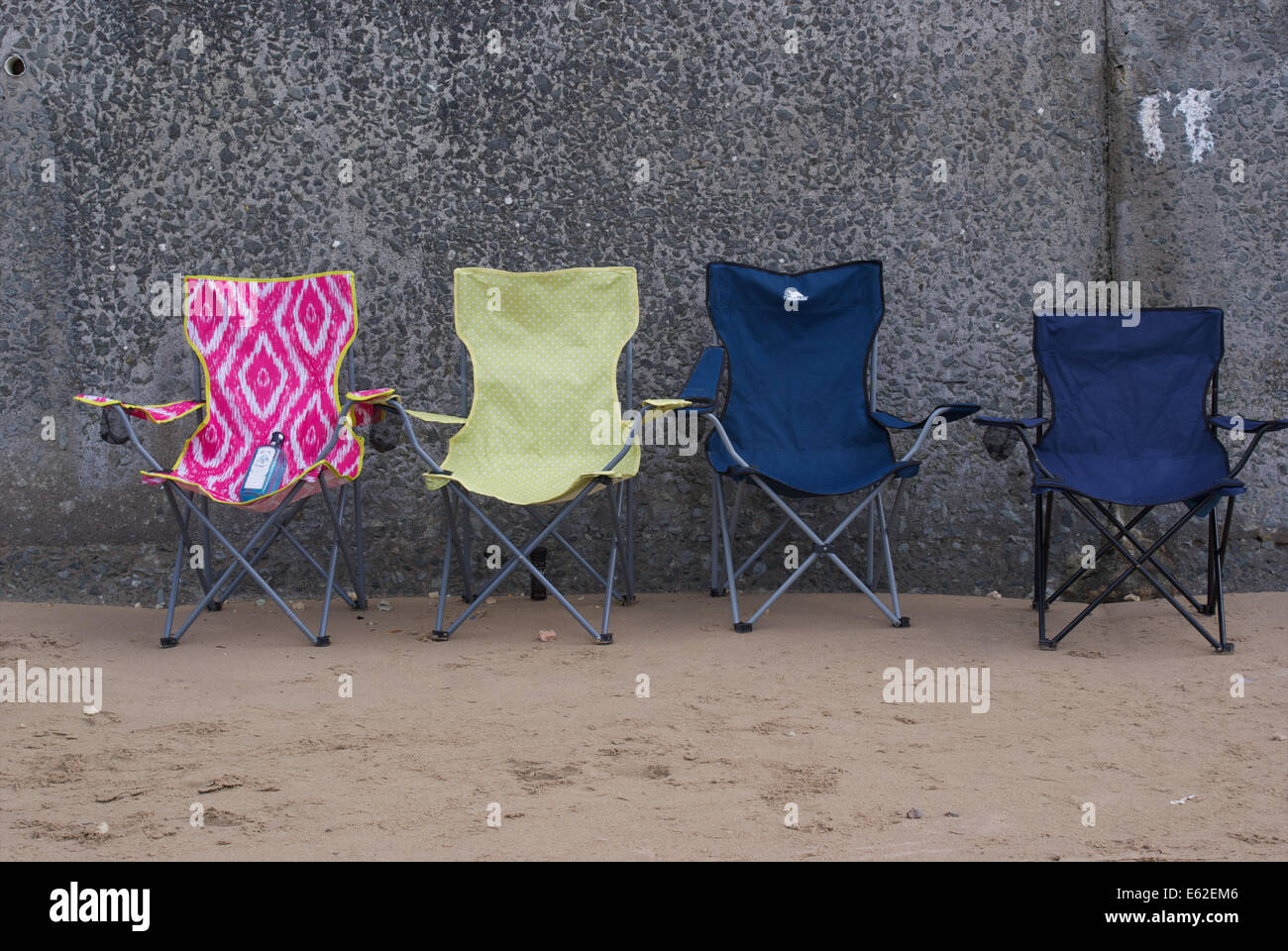 Four chairs on a beach Stock Photo - Alamy