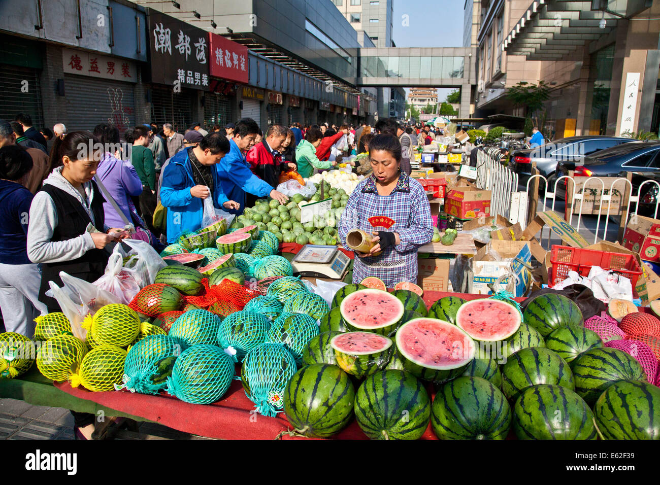 Chinese people grocery shopping for produce at an outdoor market in ...
