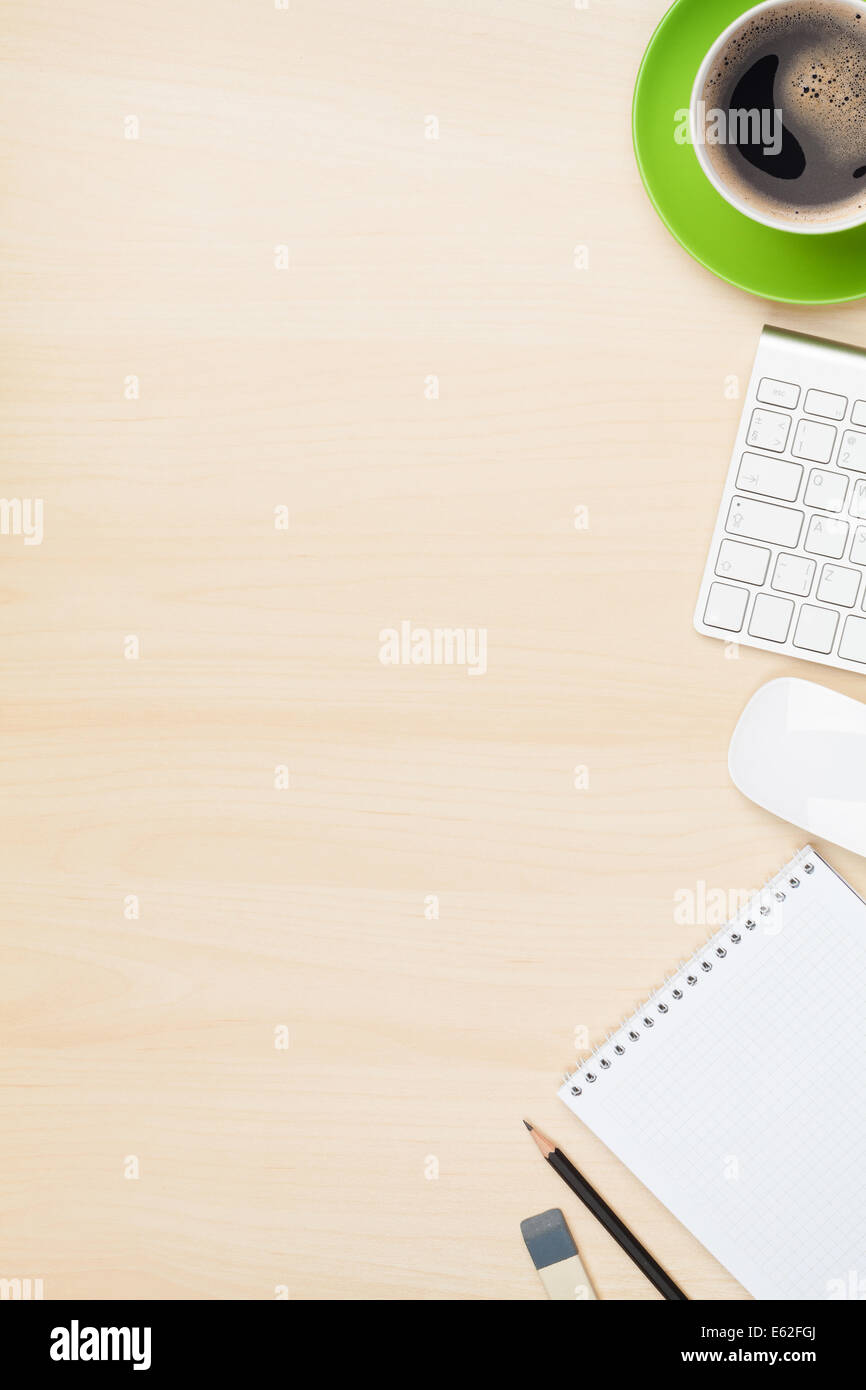 Office table with notepad, computer and coffee cup. View from above ...