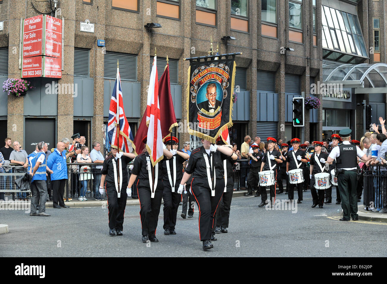 Female members of the East Bank Protestant Boys Flute Band carrying ...