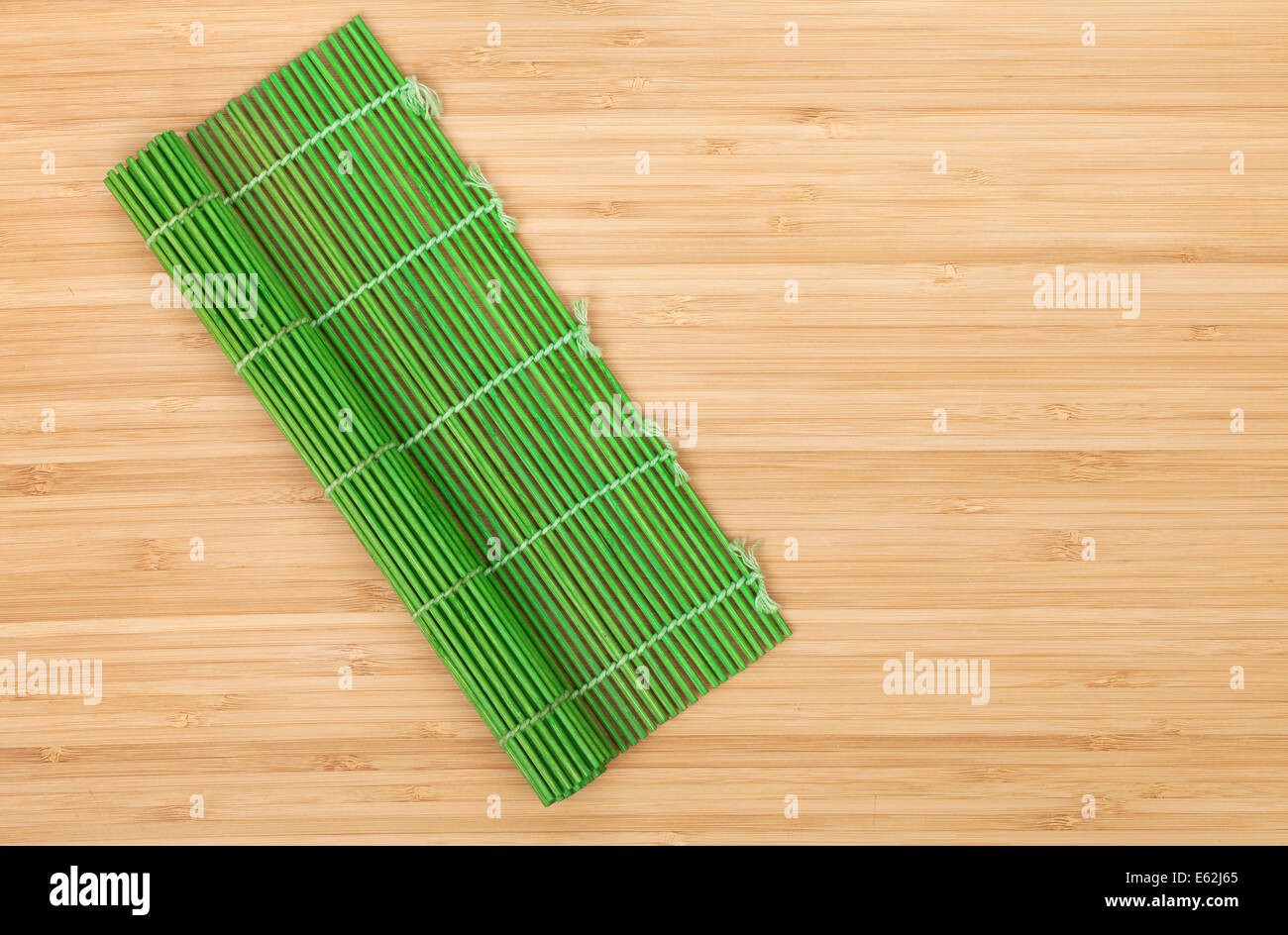 Japanese cooking mat over bamboo table with copy space Stock Photo - Alamy