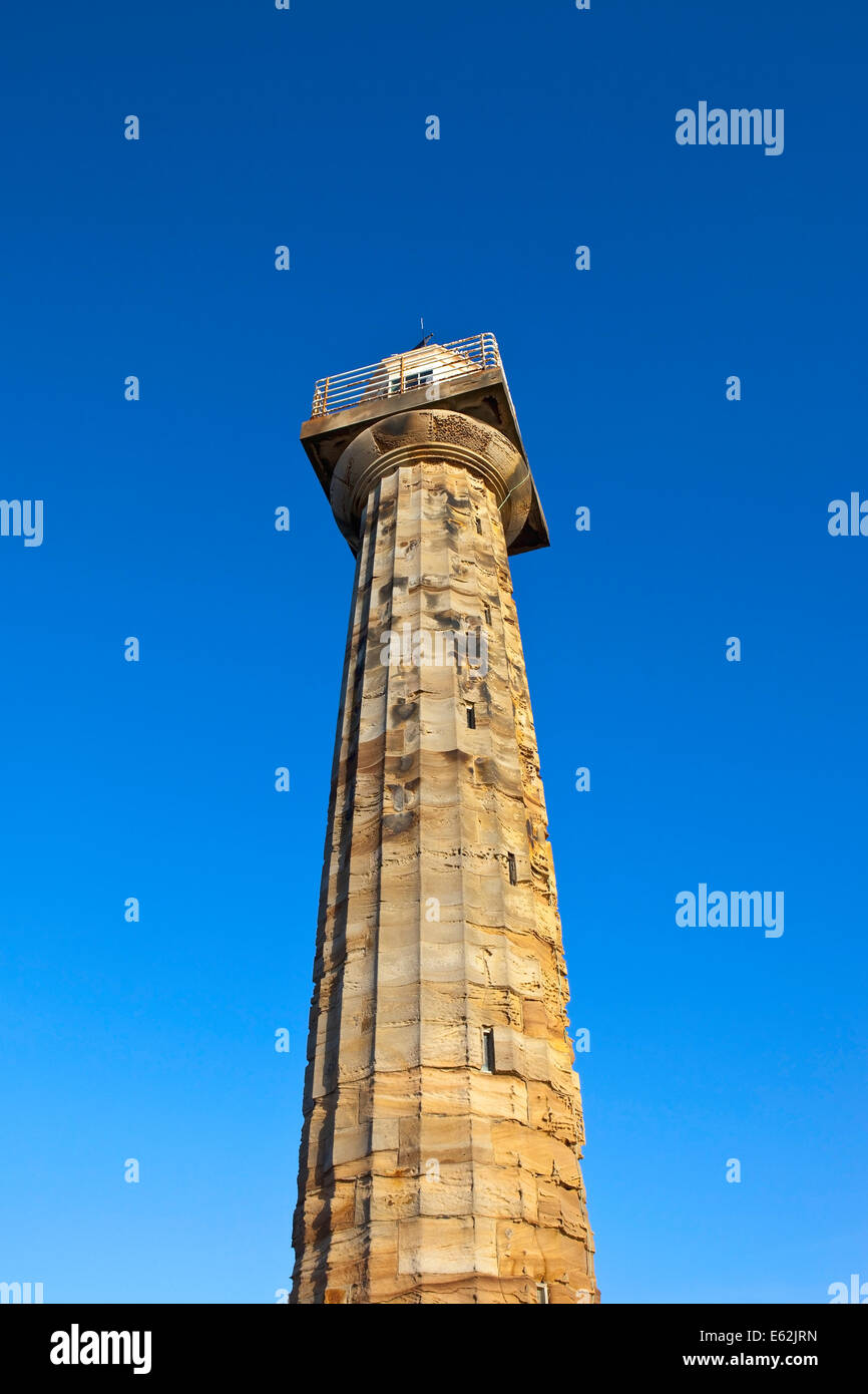 The eroded stone coastal light tower at Whitby harbour on the East ...