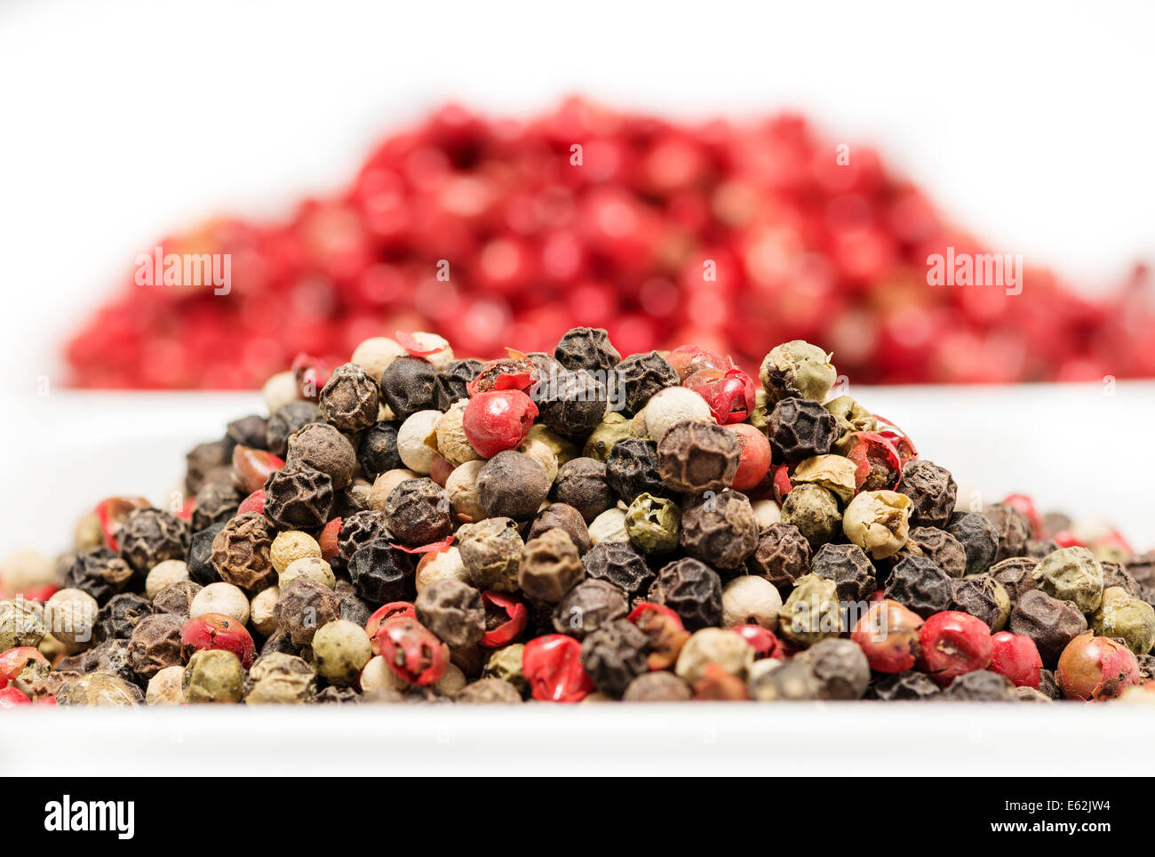 Mix pepper seeds on a white bowl Stock Photo - Alamy