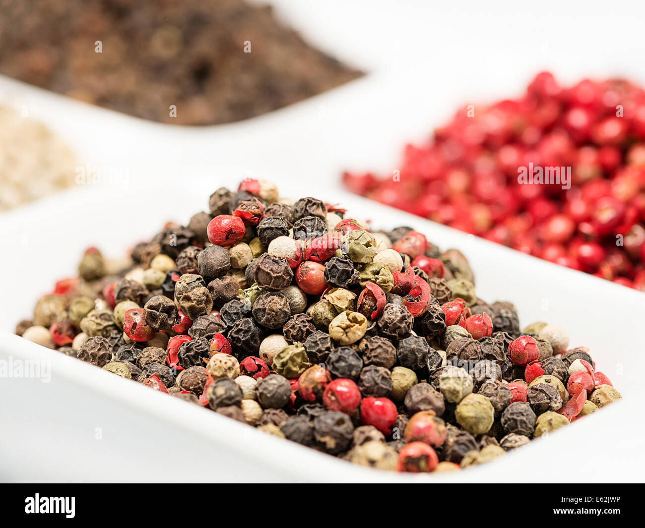 Mix pepper seeds on a white bowl Stock Photo - Alamy