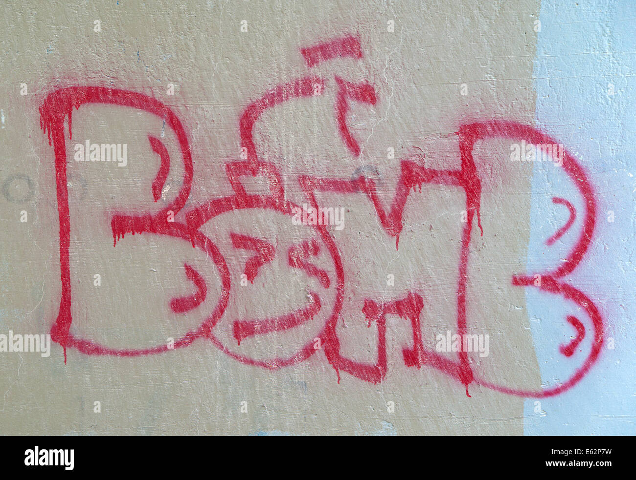 A bright red bomb graffiti logo on a concrete wall Stock Photo - Alamy