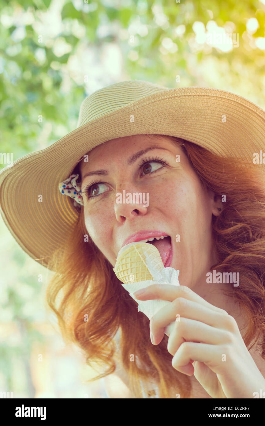 Beautiful Girl eating ice cream cone, close up. Retro style imagery ...