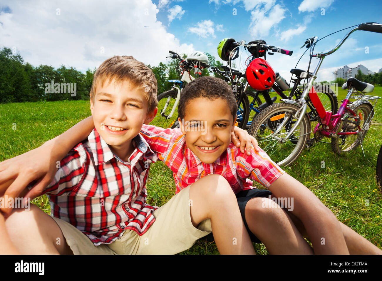 Two best friends sit on grass and hug with arms Stock Photo - Alamy