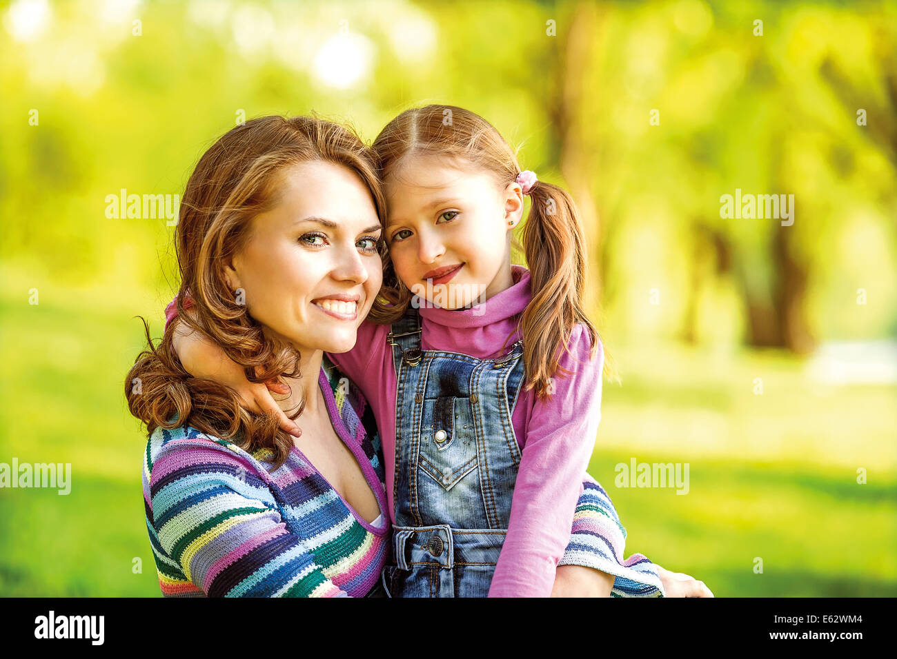 mother and daughter hugging in love playing in the park Stock Photo - Alamy